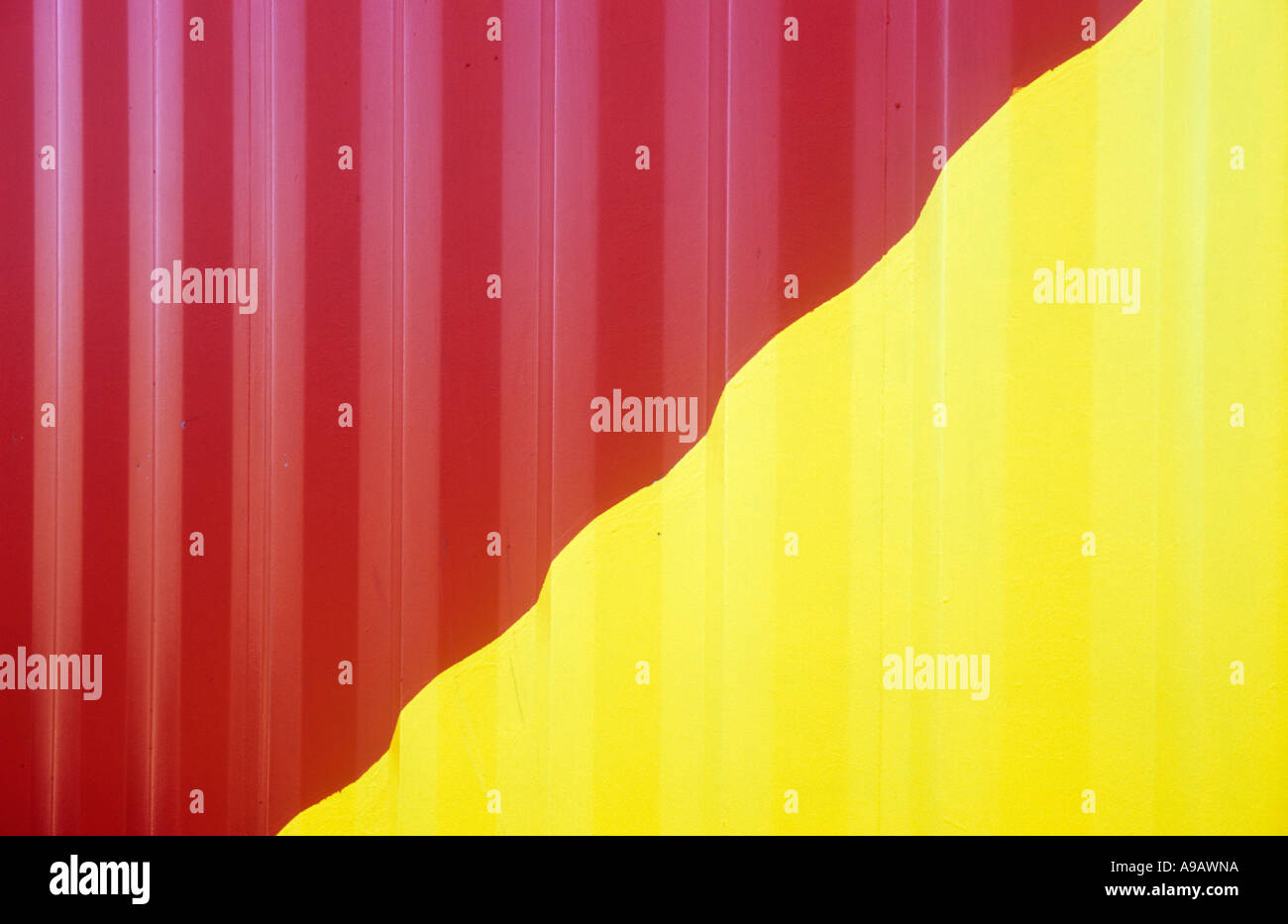 Brightly painted red and yellow side of a warehouse or workshop or ...