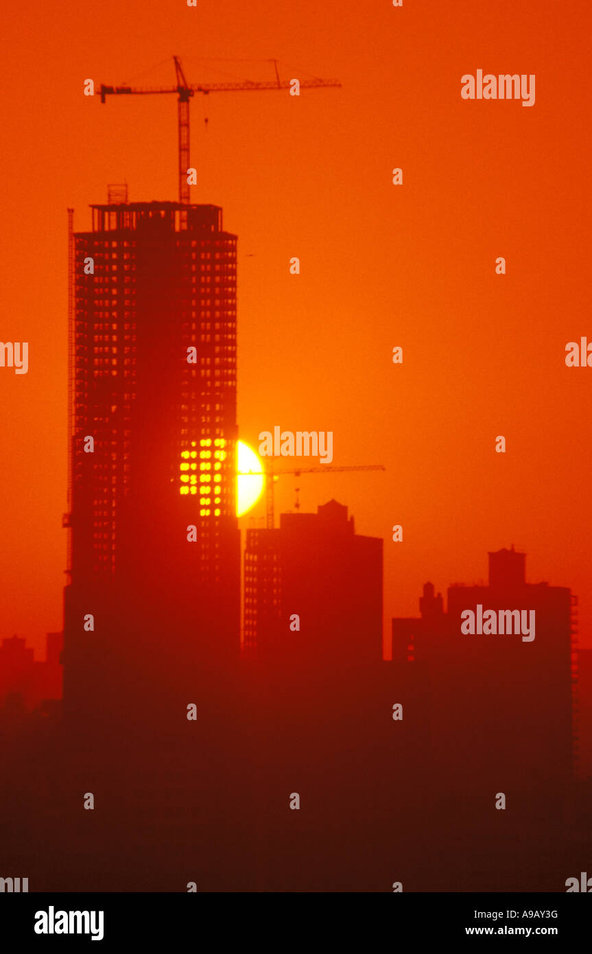 LARGE SUN GLOBE SEEN THROUGH URBAN COMMERCIAL BUILDING CONSTRUCTION ...