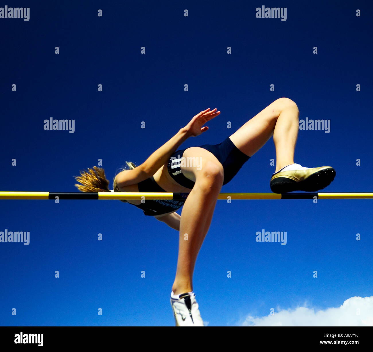 Teenage girl high jumping Stock Photo - Alamy