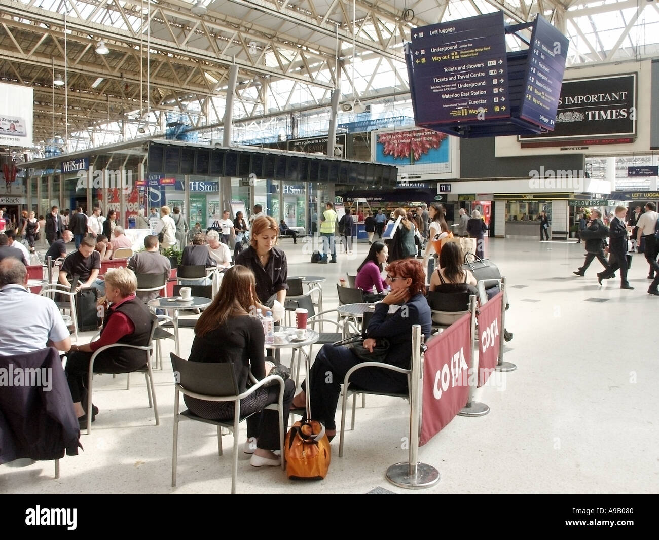 Waterloo railway terminal station concourse people sitting at snack bar ...