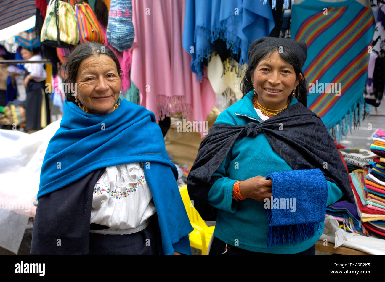 Ecuador Otavalo Market Women in traditional dress smiling with fabric ...