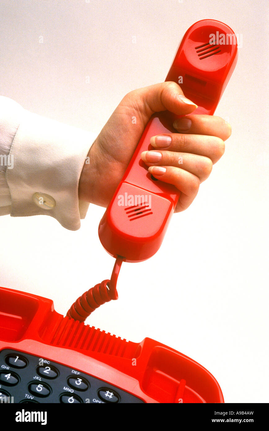 WOMANS HAND HOLDING RED TELEPHONE HANDSET Stock Photo - Alamy