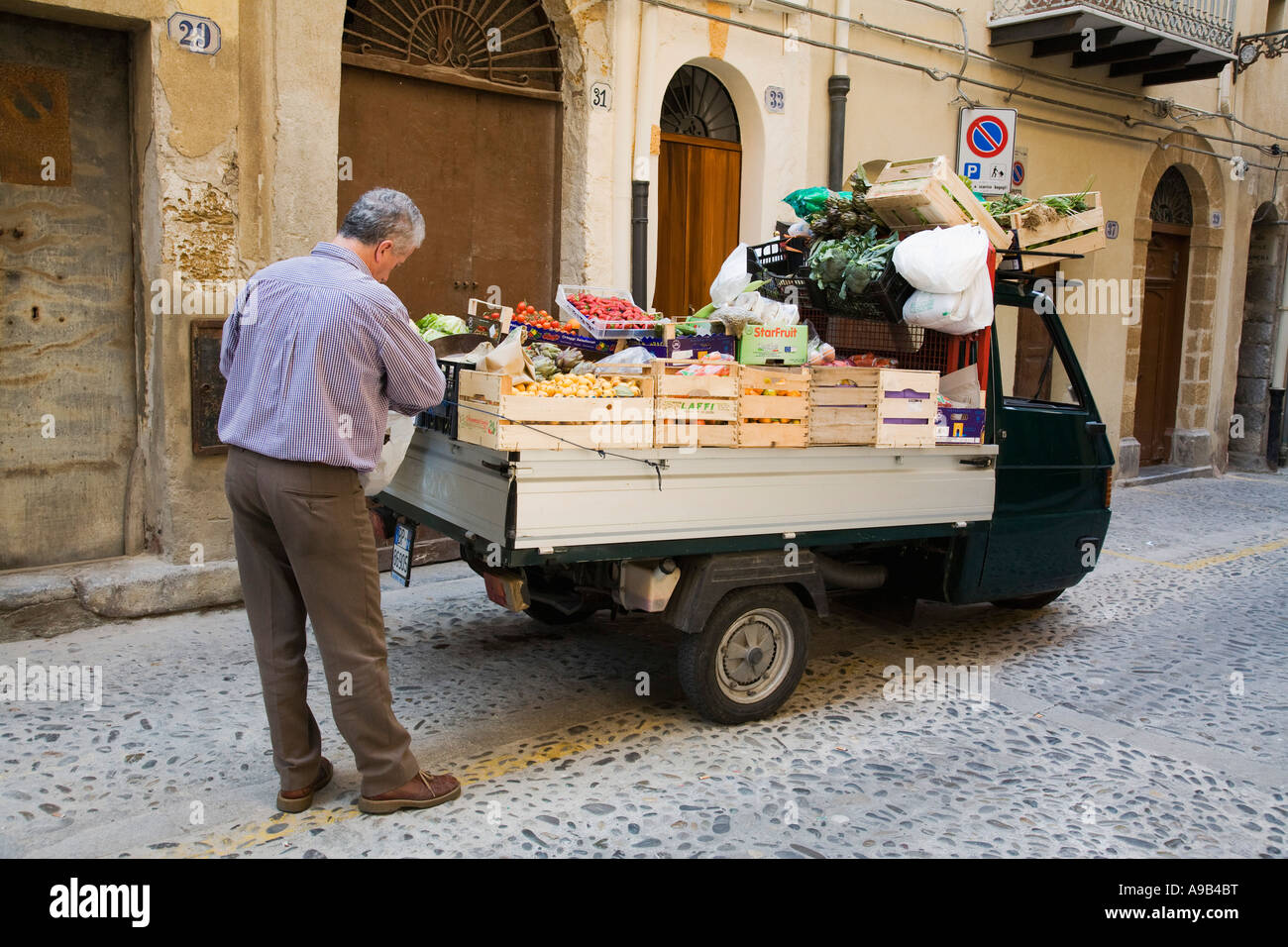 Fruit vendor on neighborhood street Cefalu Sicily Italy Stock Photo - Alamy