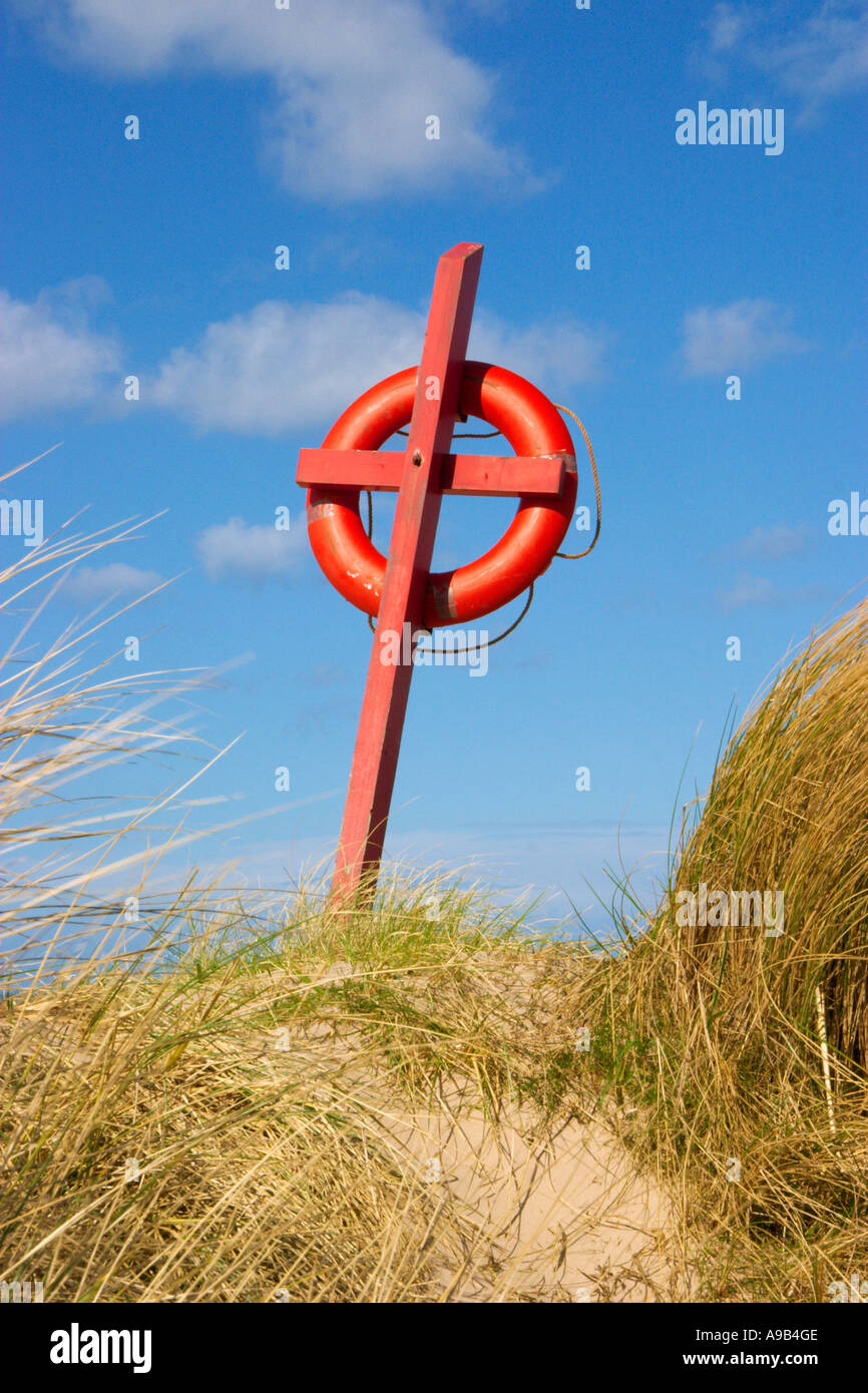 Red life ring on beach, UK Stock Photo - Alamy