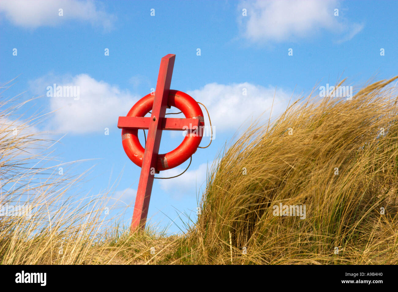 Red life ring on beach, UK Stock Photo - Alamy