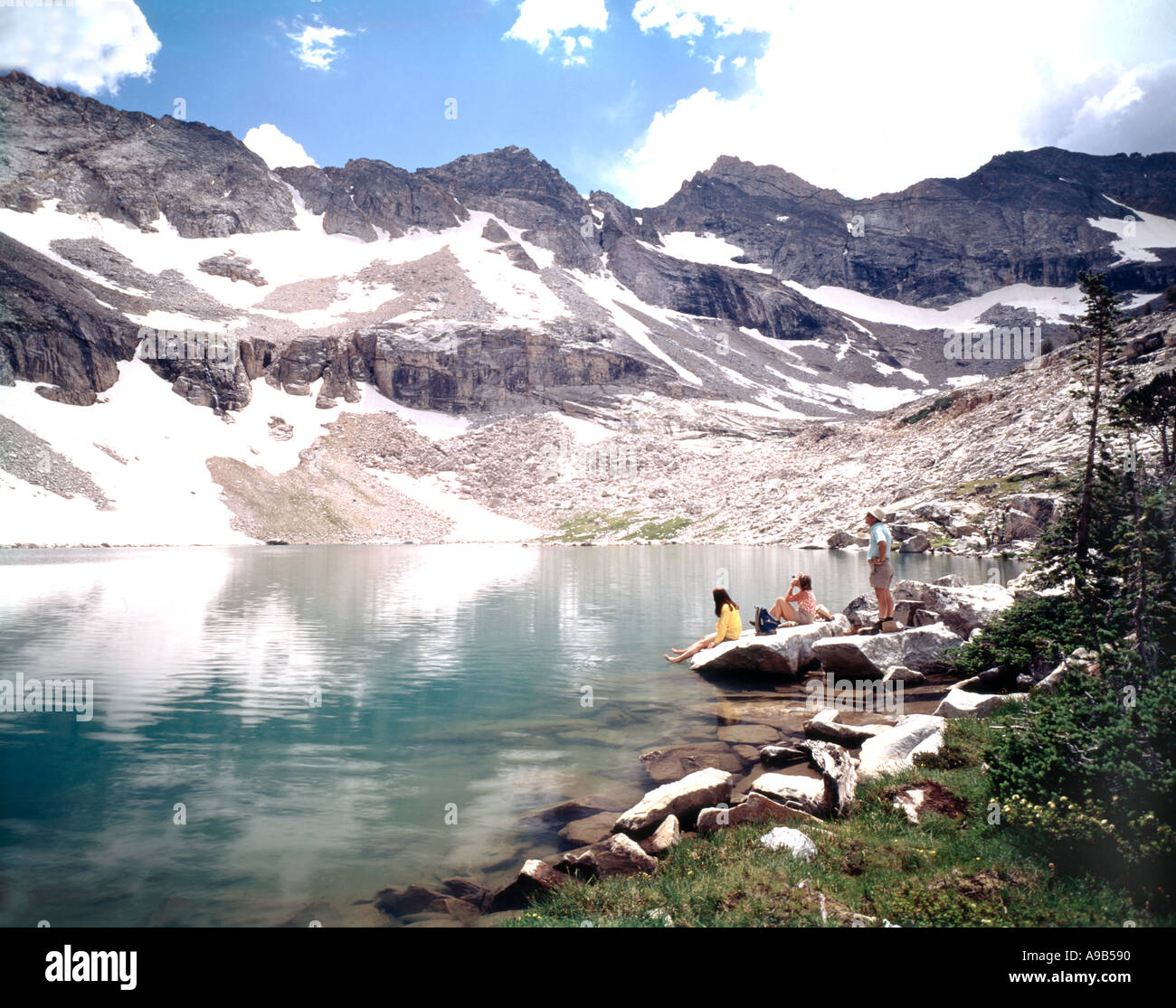 Hikers take a break to enjoy the view at Boulder Lake in the Pioneer ...