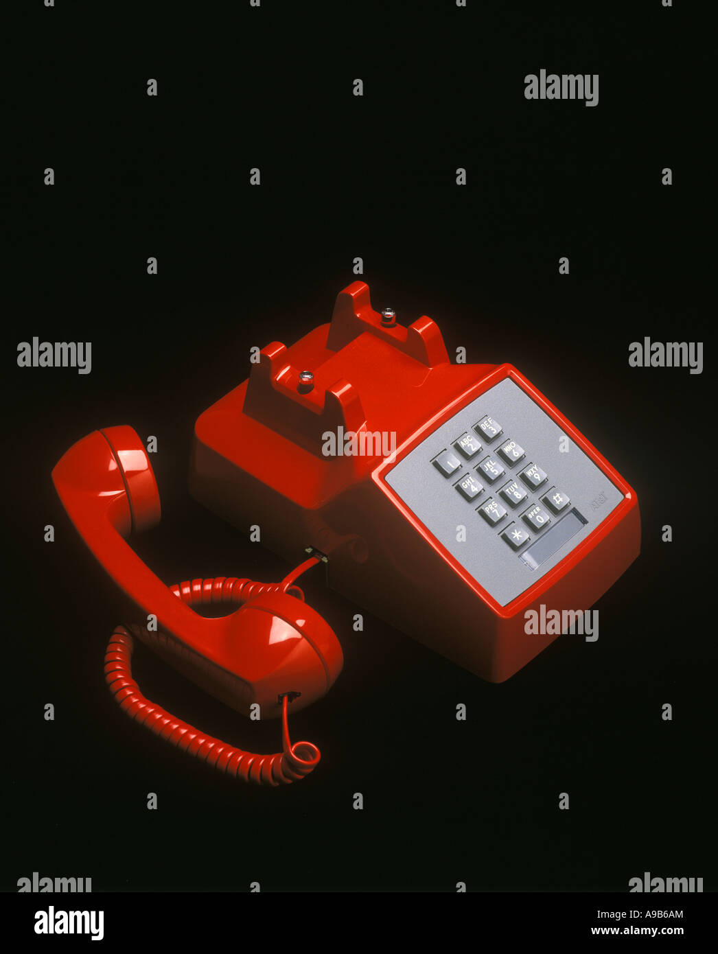 HANDSET OFF TRADITIONAL RED PUSH BUTTON TELEPHONE ON BLACK BACKGROUND ...