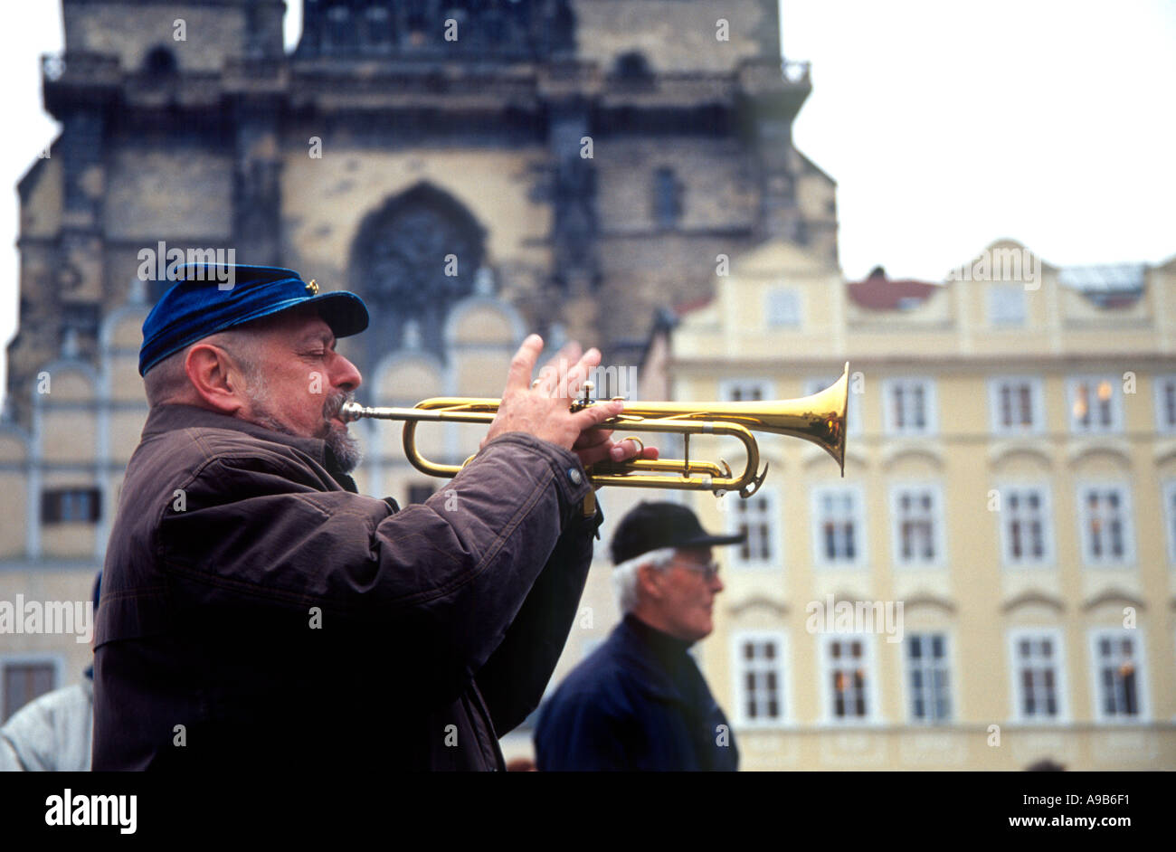 Street musicians playing a trumpet in the Old Town Square Church of Our ...