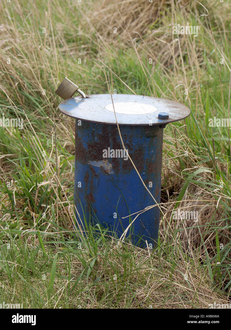 Bore hole or borehole inspection cover in a field Stock Photo - Alamy