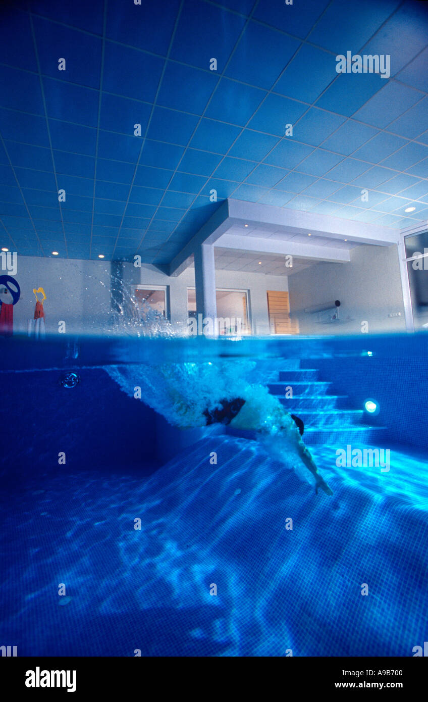Man diving in indoor swimming pool of a residence Stock Photo - Alamy