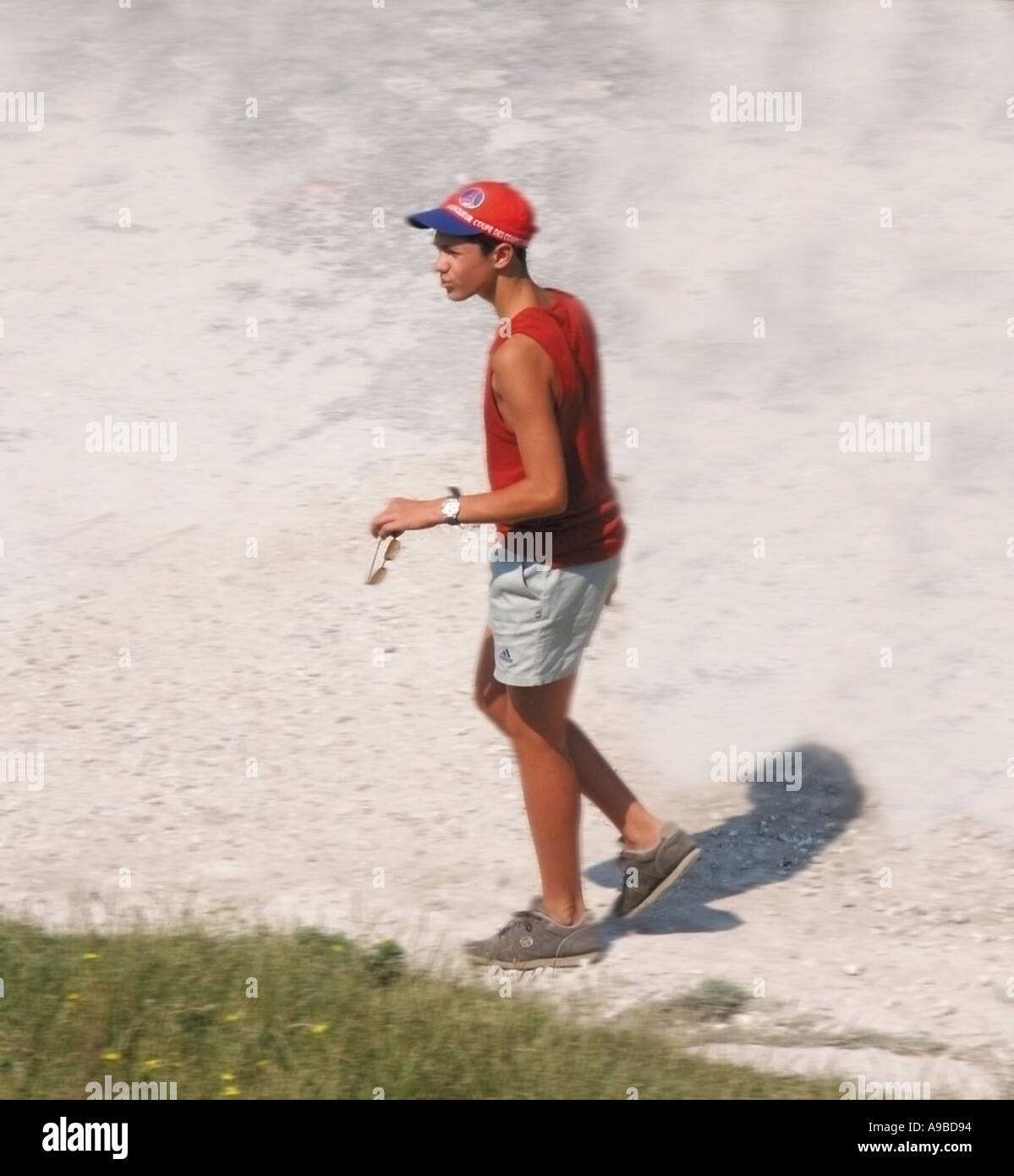 france teenage boy walking twirling sunglasses wearing holiday clothes ...