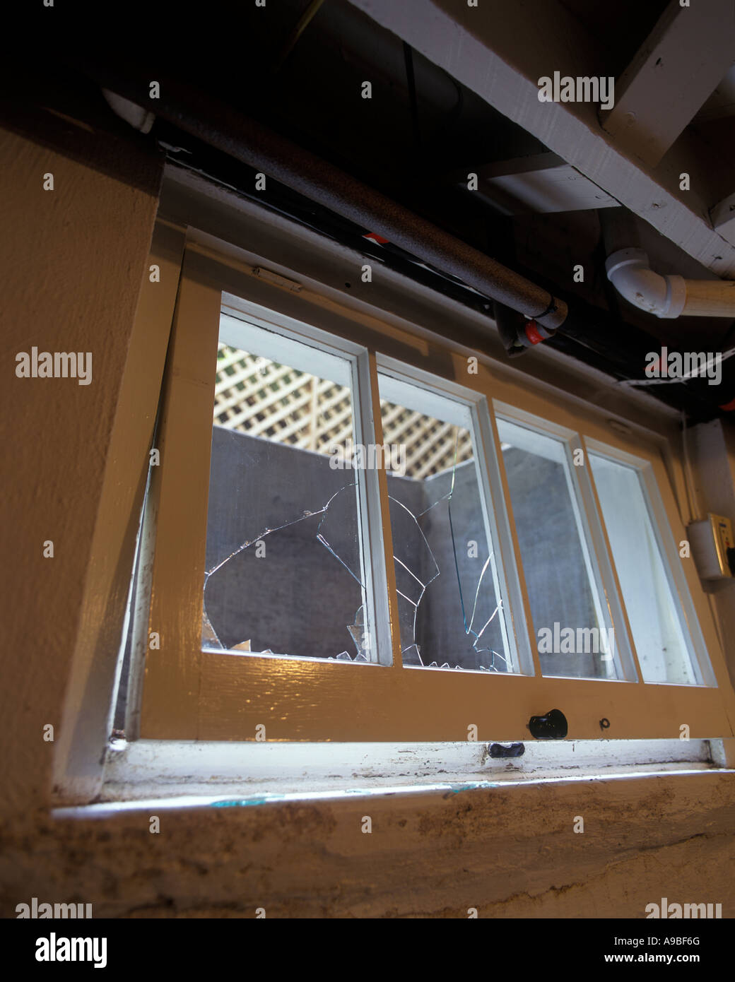 BROKEN WINDOW PANES OF FRAME OF OPEN BASEMENT WINDOW Stock Photo - Alamy