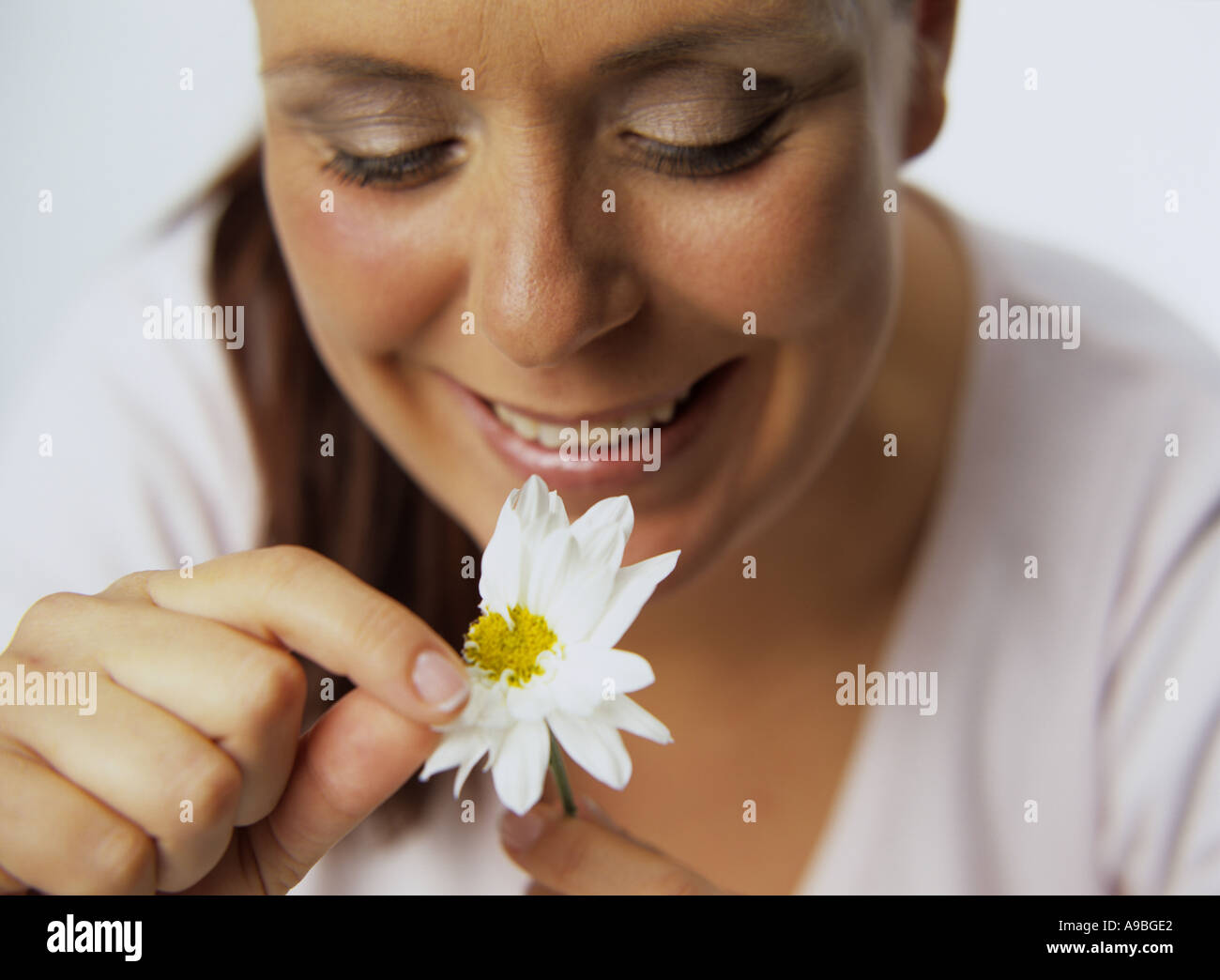 Woman plucking petals of flower Stock Photo - Alamy