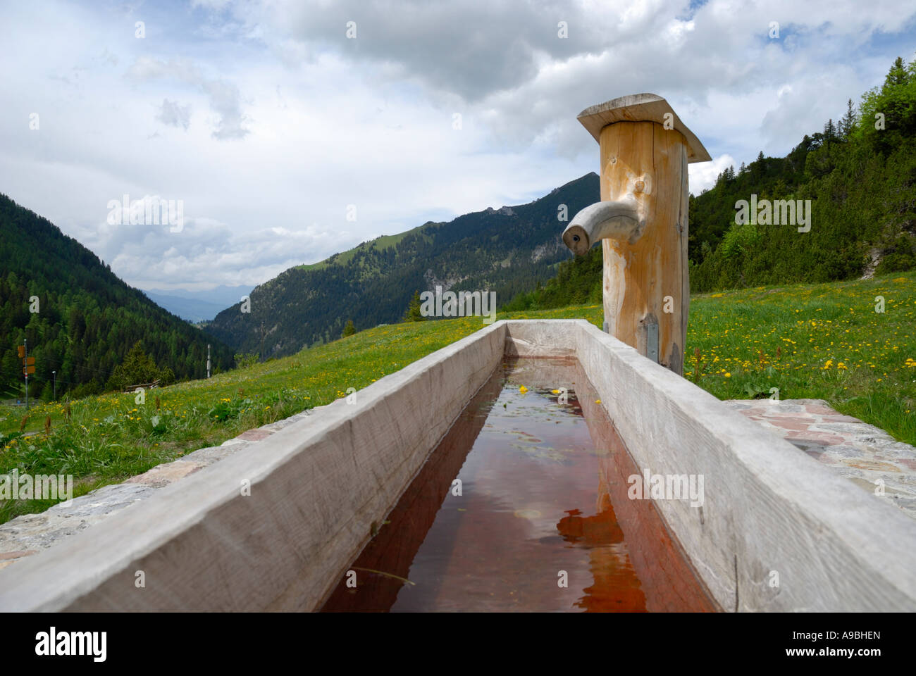 Wooden fountain of natural spring source in Malbun Stock Photo - Alamy
