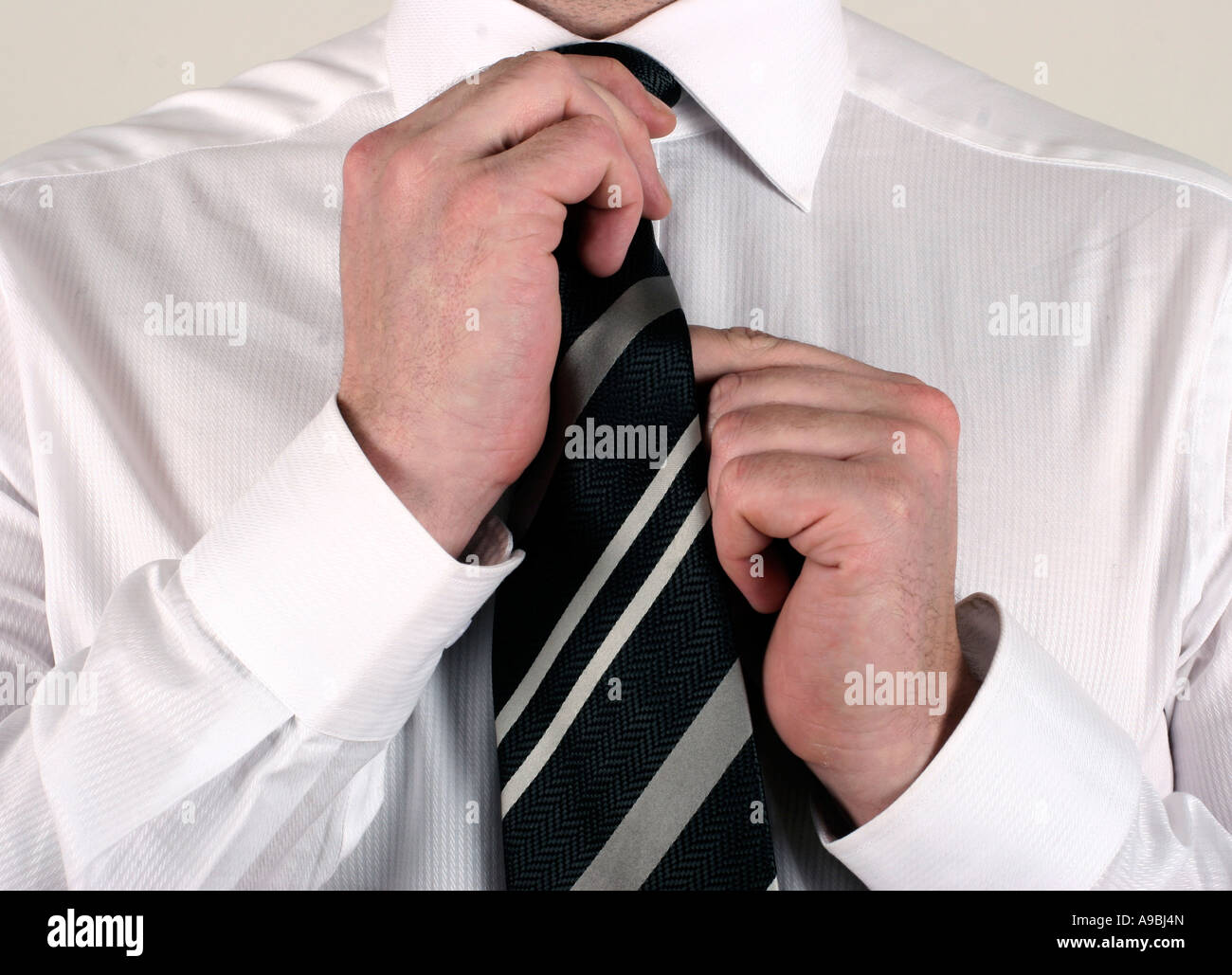 well dressed business man adjusting his neck tie Stock Photo - Alamy