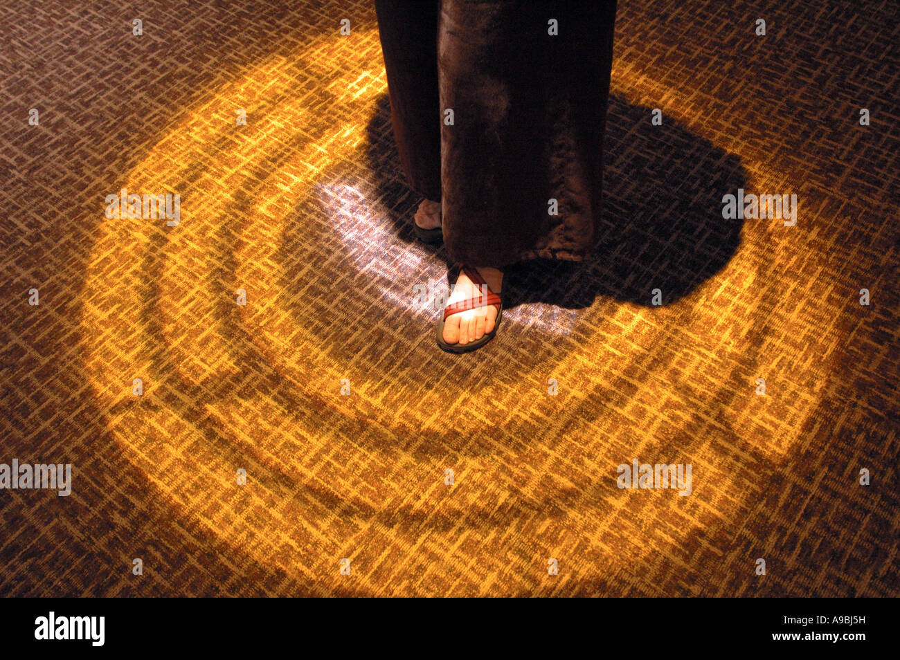 Woman's feet in a spotlight Stock Photo - Alamy