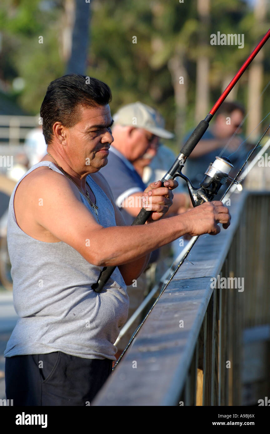 Man fishing from a pier Stock Photo - Alamy