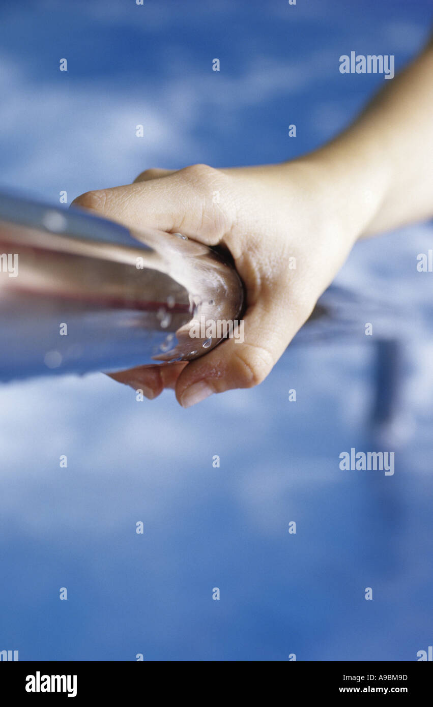Human hand holding steel bar Stock Photo - Alamy