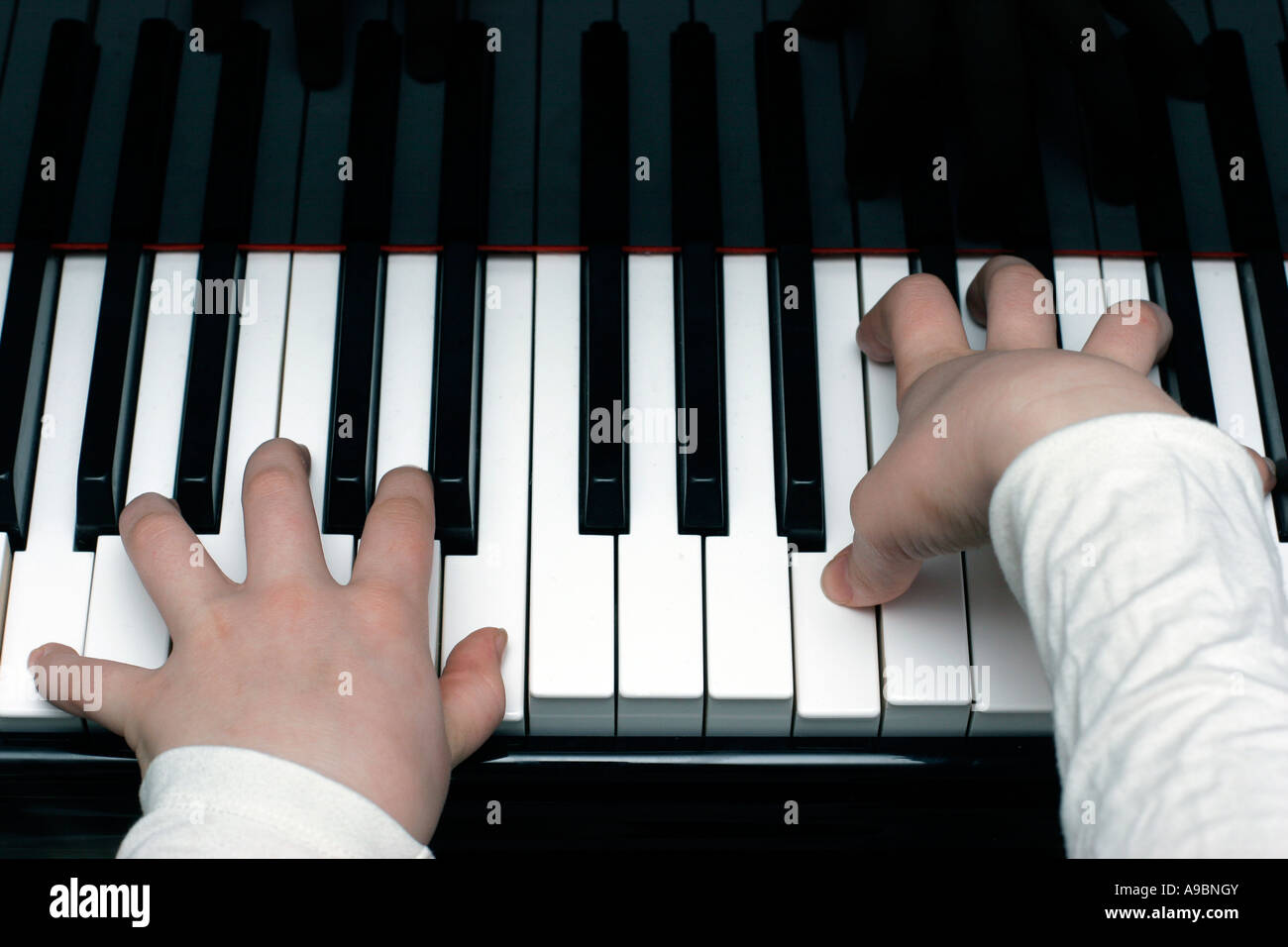 Kid playing the piano during piano lesson Stock Photo - Alamy