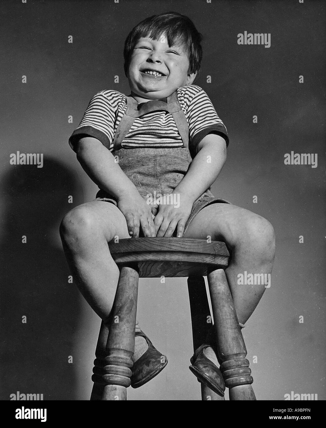 BOY ON A STOOL Stock Photo - Alamy