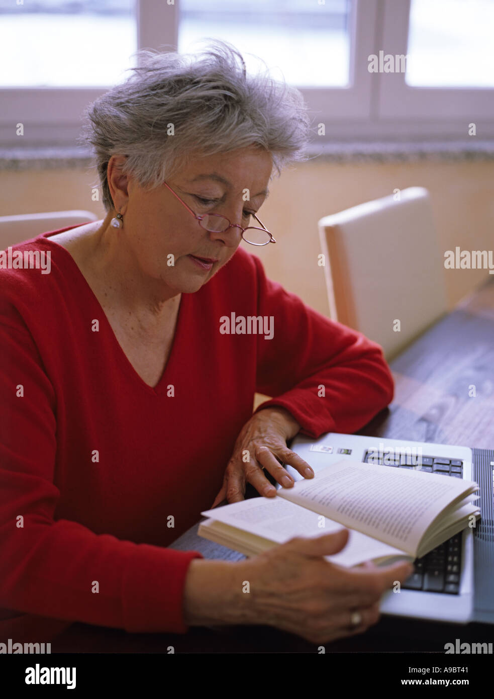 Senior woman reading book Stock Photo - Alamy