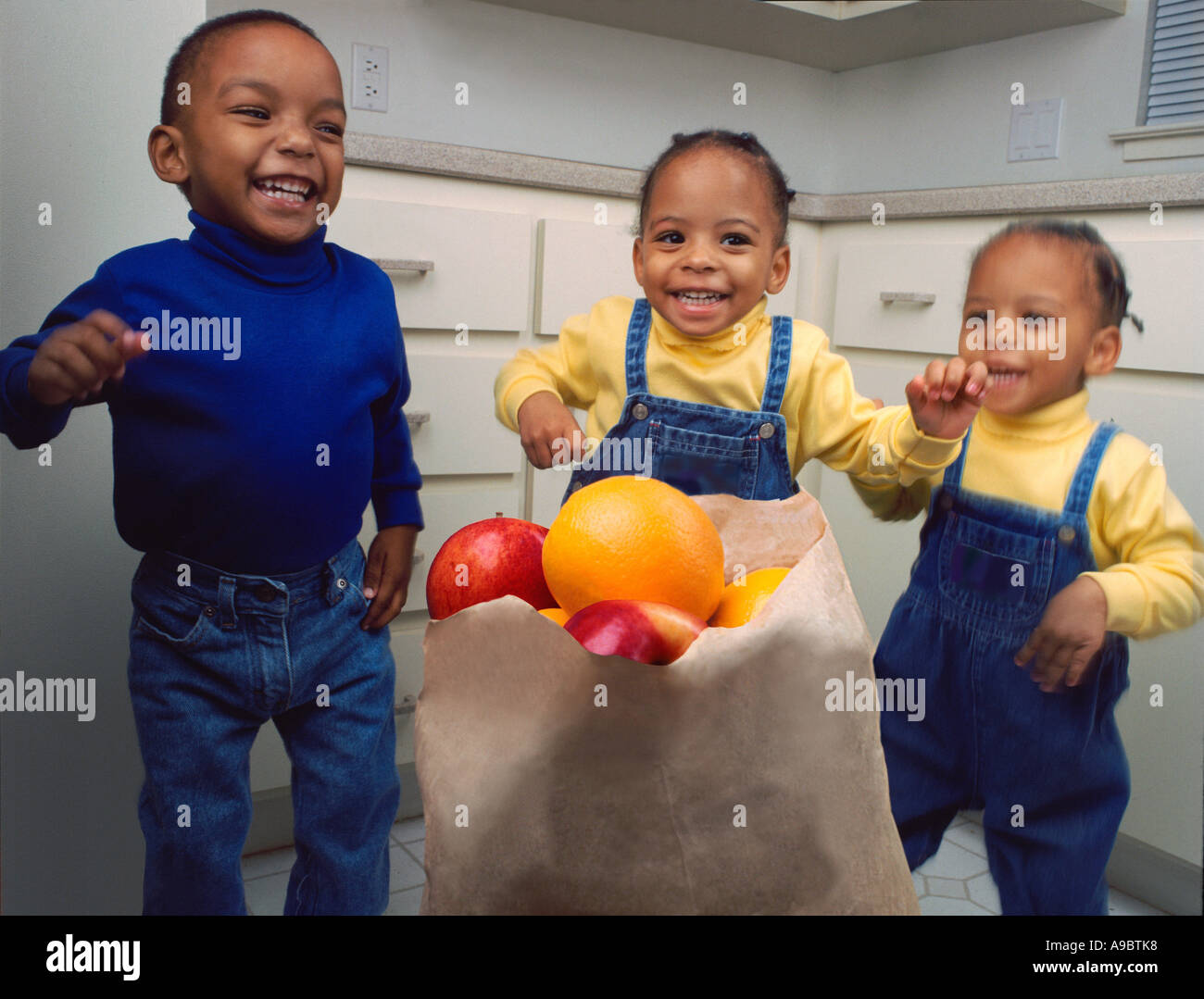 Three kids jumping happily bag hi-res stock photography and images - Alamy
