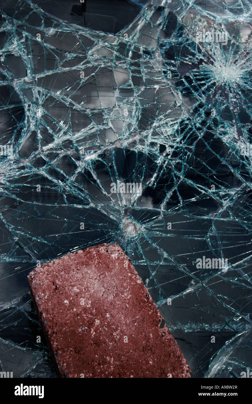 Big brick lying on a completely shattered windshield Stock Photo - Alamy