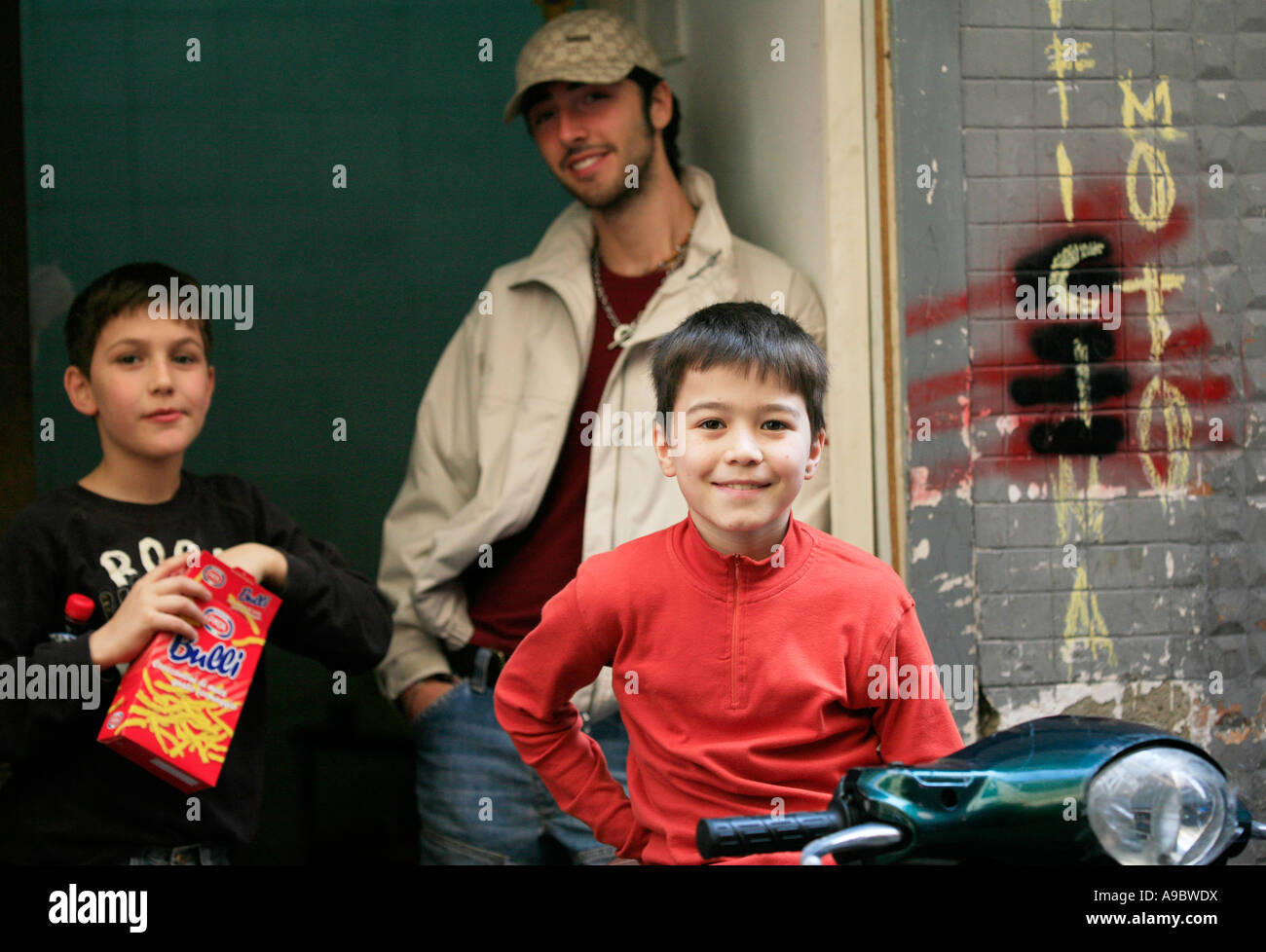 Father and 2 young sons in poor district of Naples Italy Stock Photo ...