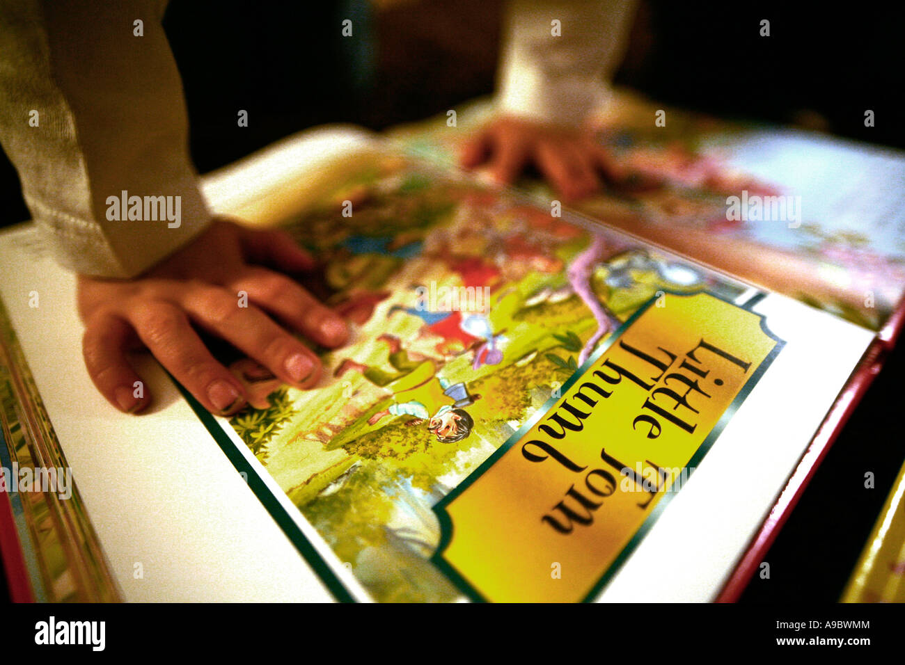 Hands of toddler on childrens book Stock Photo - Alamy