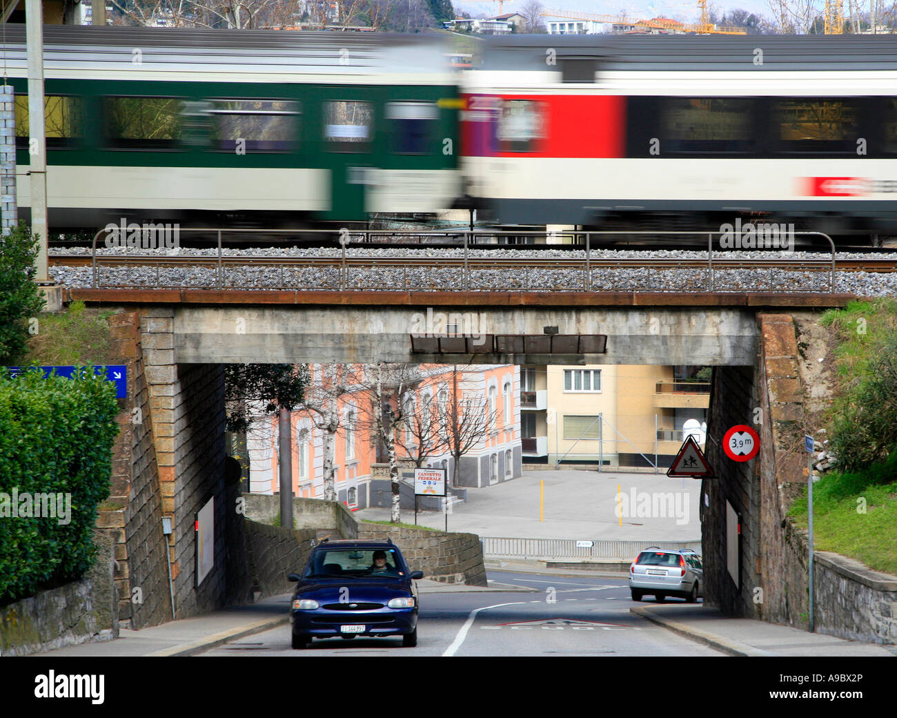 Car under bridge with moving train in Lugano Switzerland Stock Photo ...