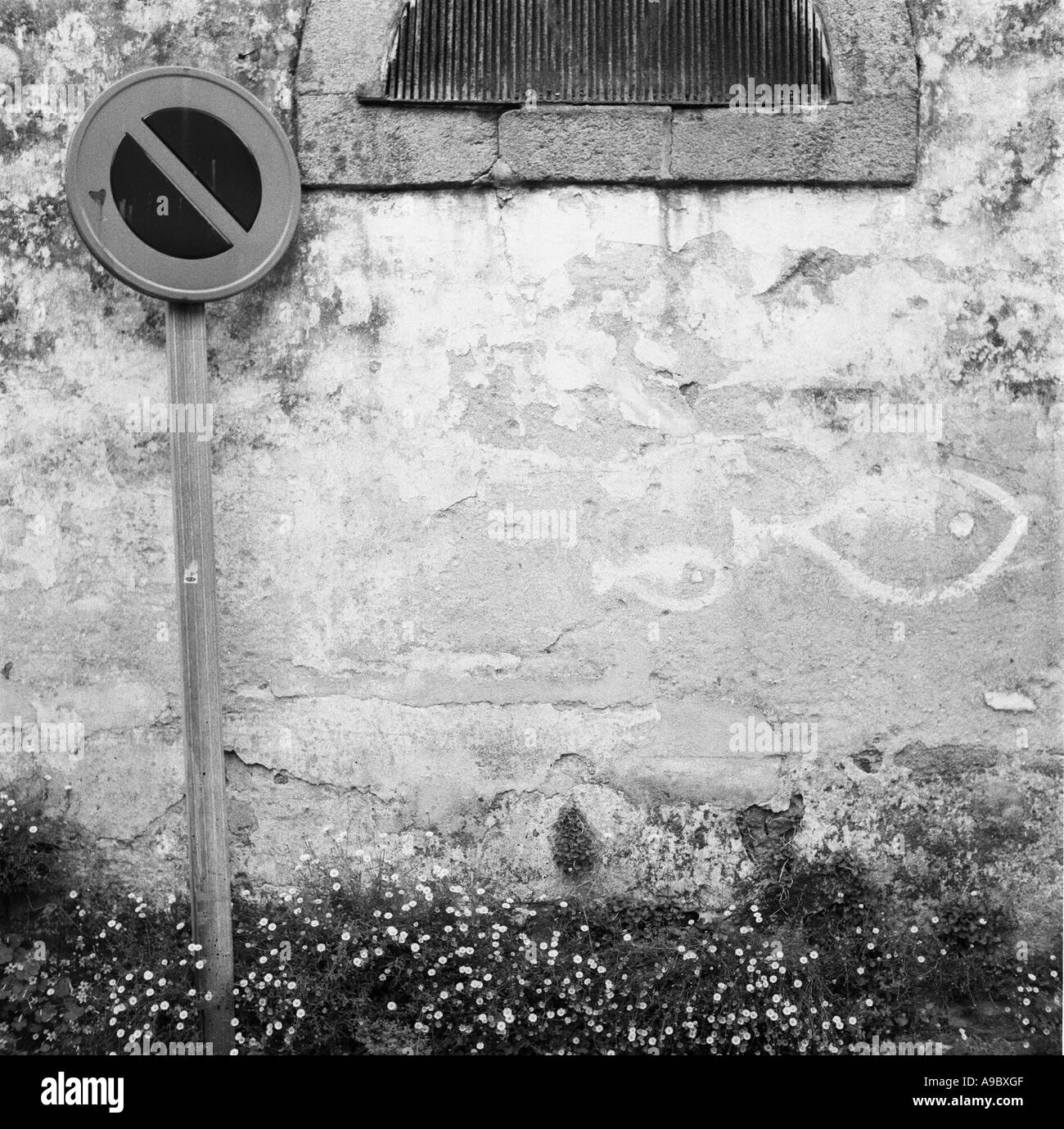 A wall with painted designs and road sign, Brittany, France Stock Photo ...