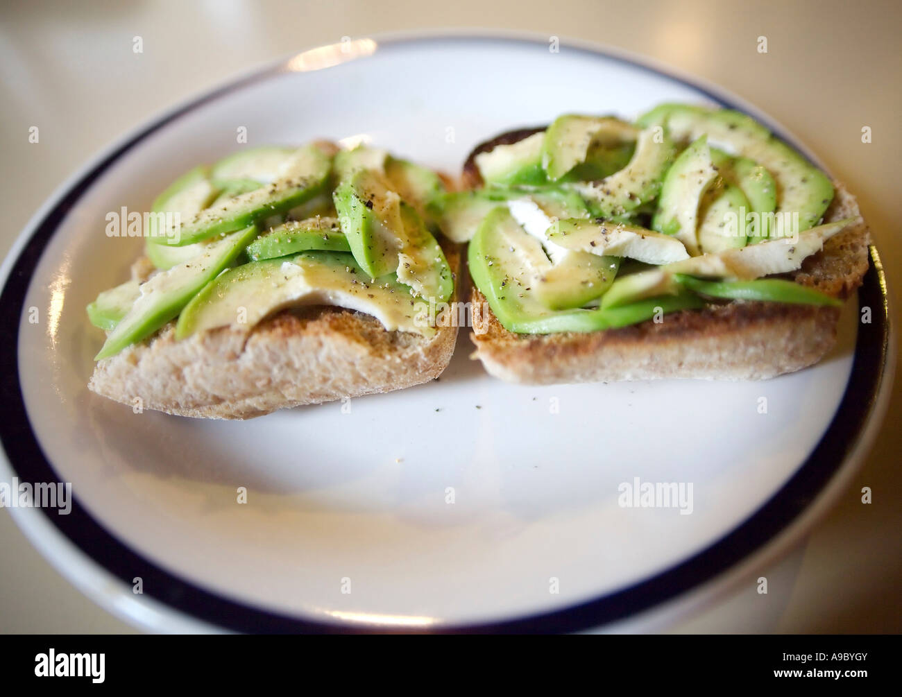Sliced avocado on toasted brown bap Stock Photo - Alamy