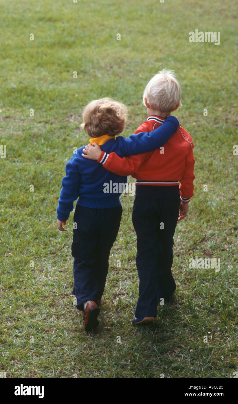 small boy and girl walking with arms around each other Stock Photo - Alamy
