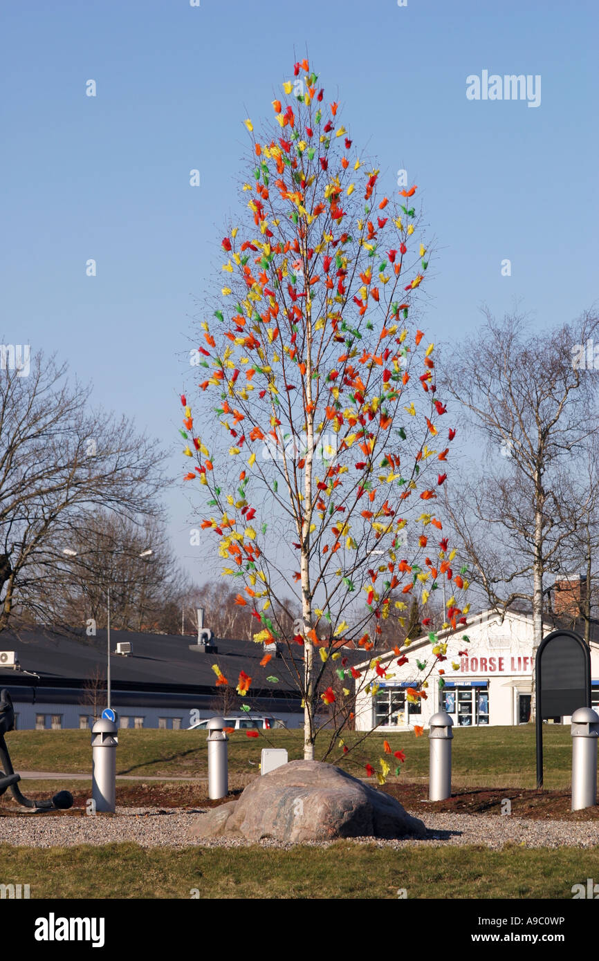 Birch treee with colorful feathers as an easter decoration in a ...