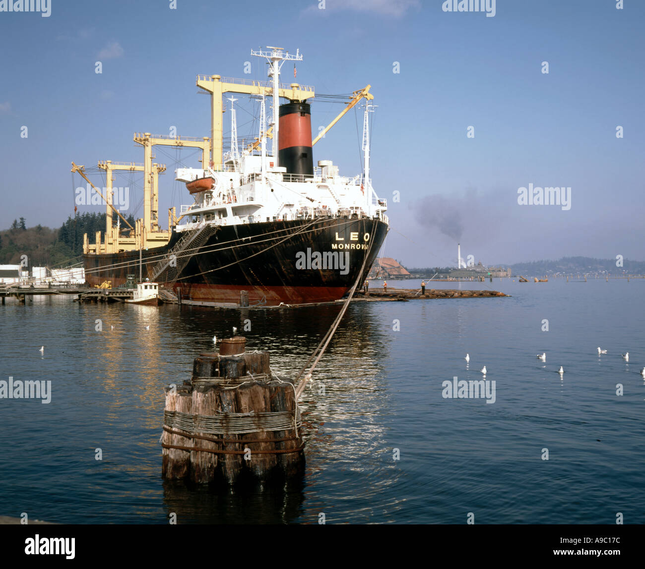 Ocean freighter Mercury Island busy loading Oregon logs in the Port of ...