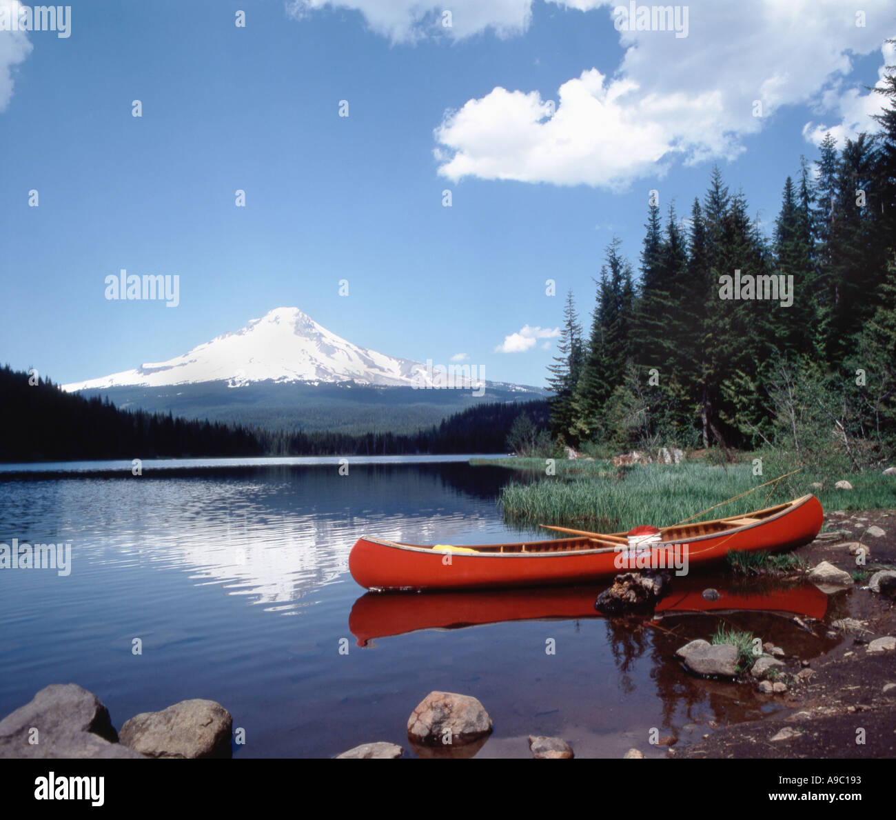 Trillium Lake showing a red beached canoe and 11 237 foot high Mount ...