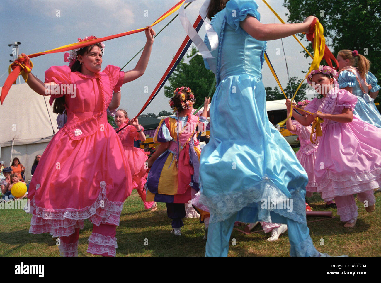 Children dancing around the Maypole at a summer fair in Dulwich park ...