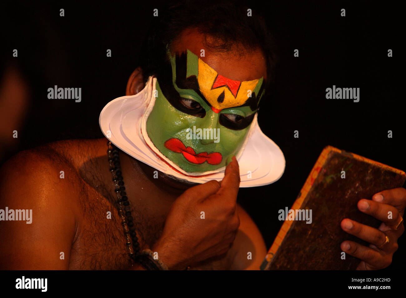 Katakali Dancer applying his make-up, Kerala, South India Stock Photo ...