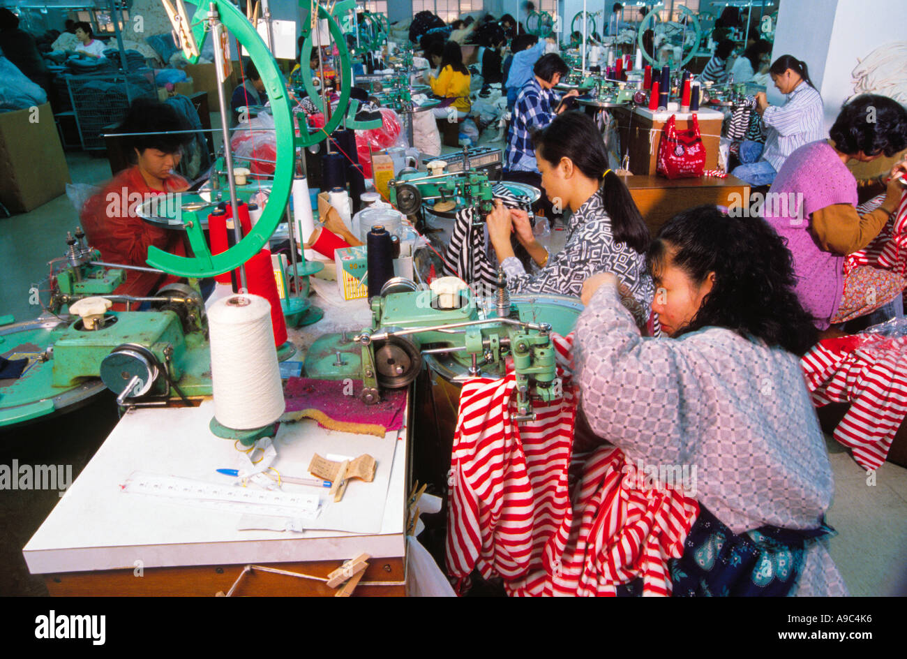 Textile factory worker at work china Stock Photo - Alamy