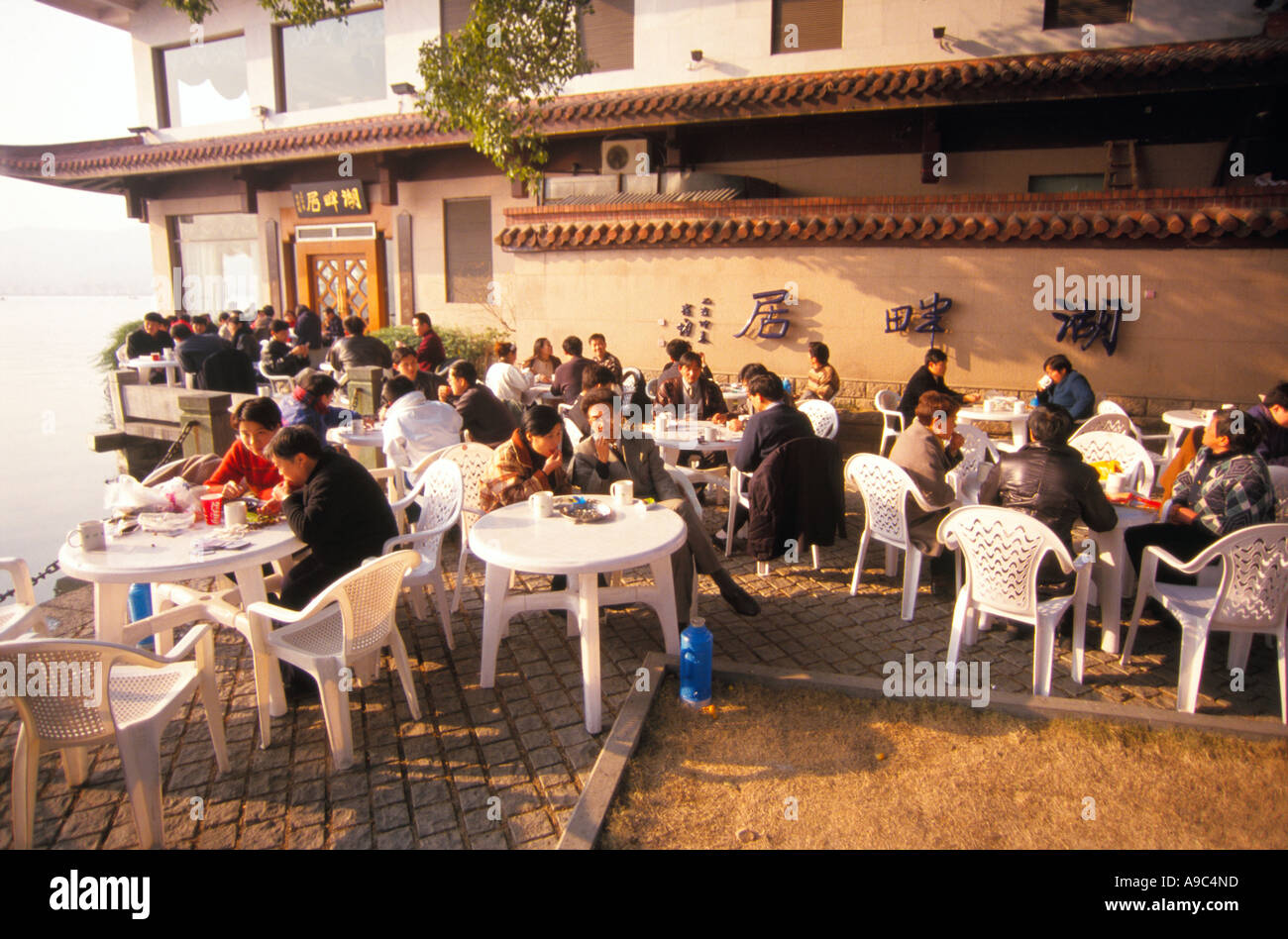 people enjoying tea in tea garden west lake hangzhou Jiangsu province ...