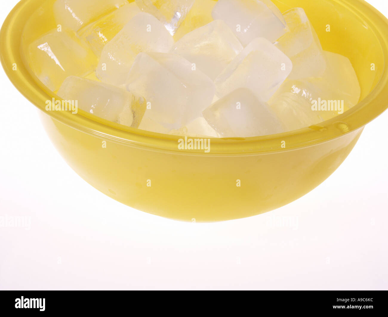 Ice cubes in a yellow bowl Stock Photo - Alamy