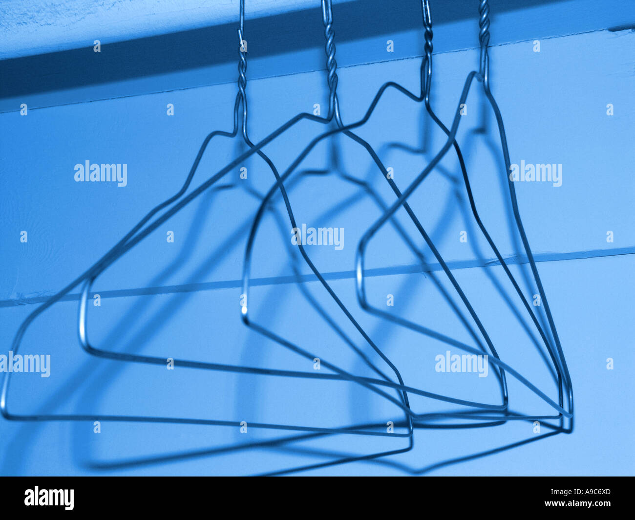 Empty wire coathangers in a closet Stock Photo - Alamy