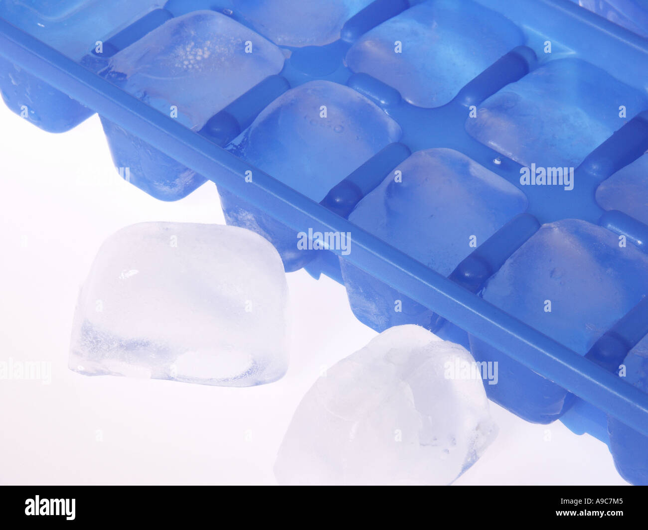 Ice cubes in a blue tray Stock Photo - Alamy