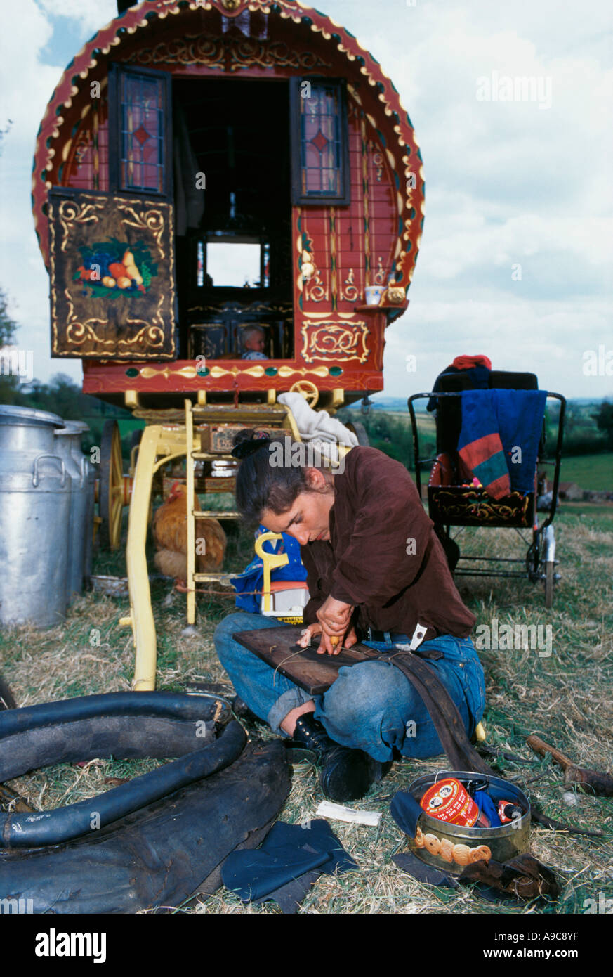 Gypsy repairing wheel caravan Applyby fair England Stock Photo - Alamy