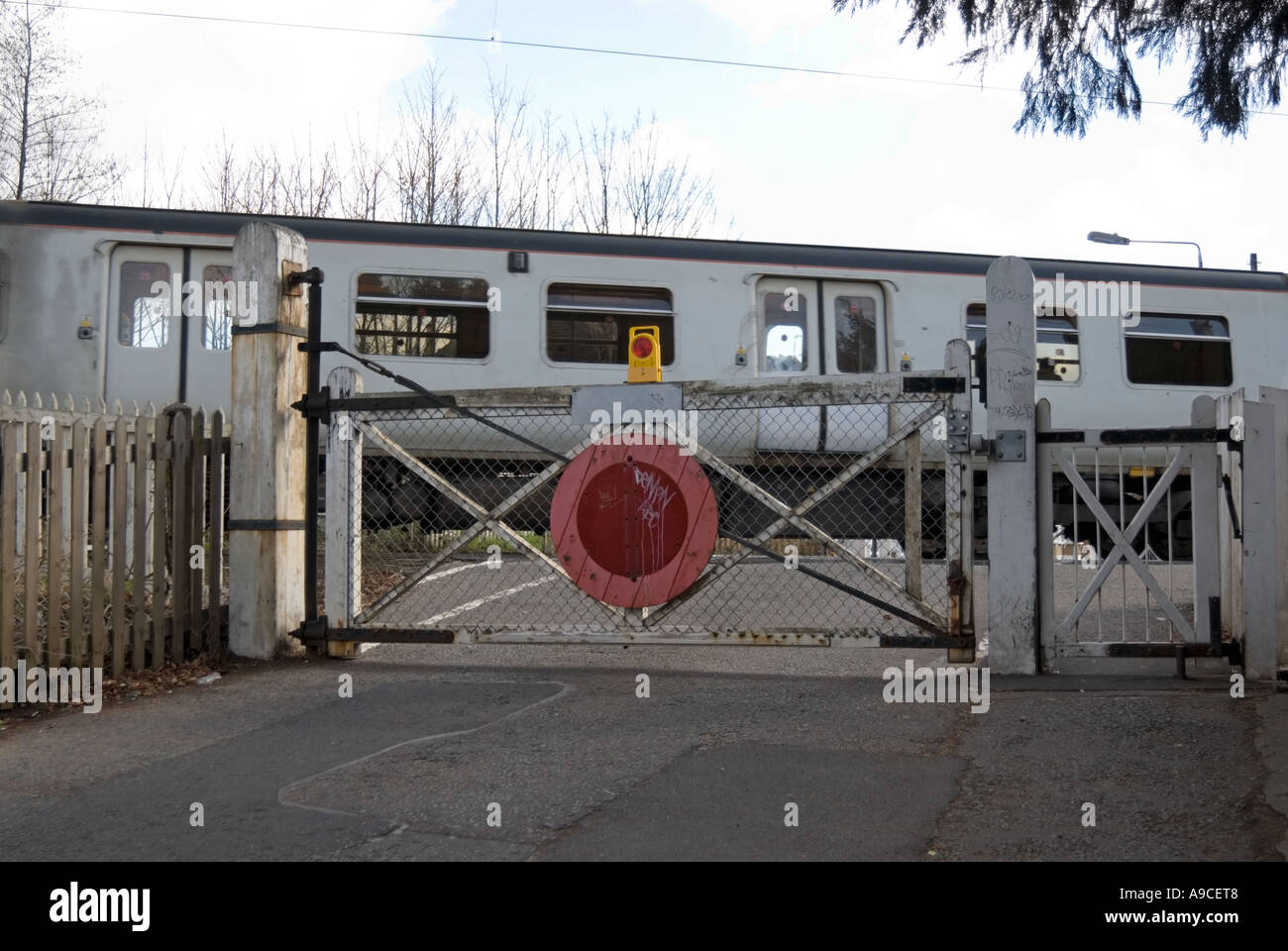 Train passing manned railway level crossing Stock Photo - Alamy