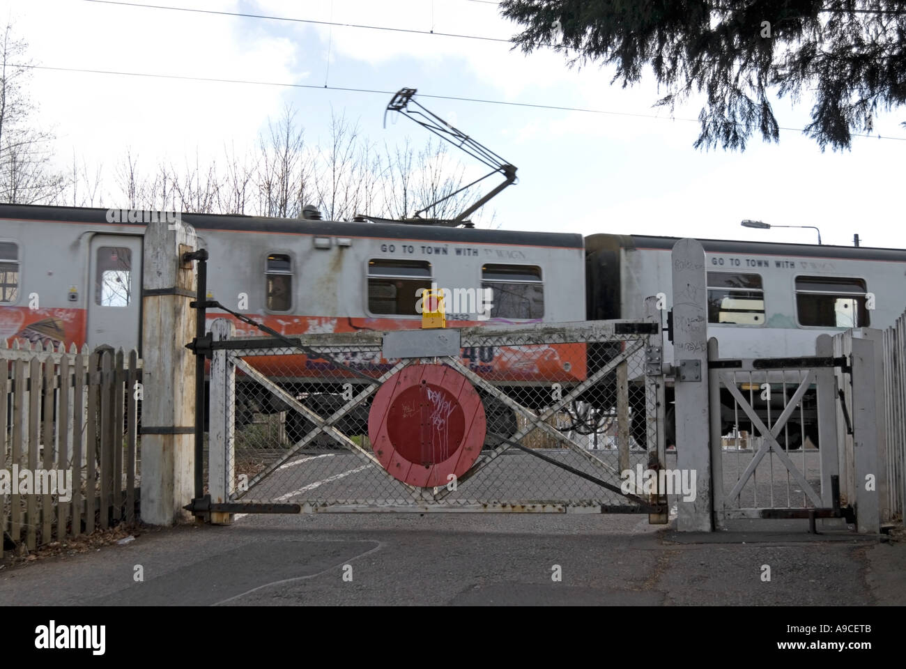 Train passing manned railway level crossing Stock Photo - Alamy