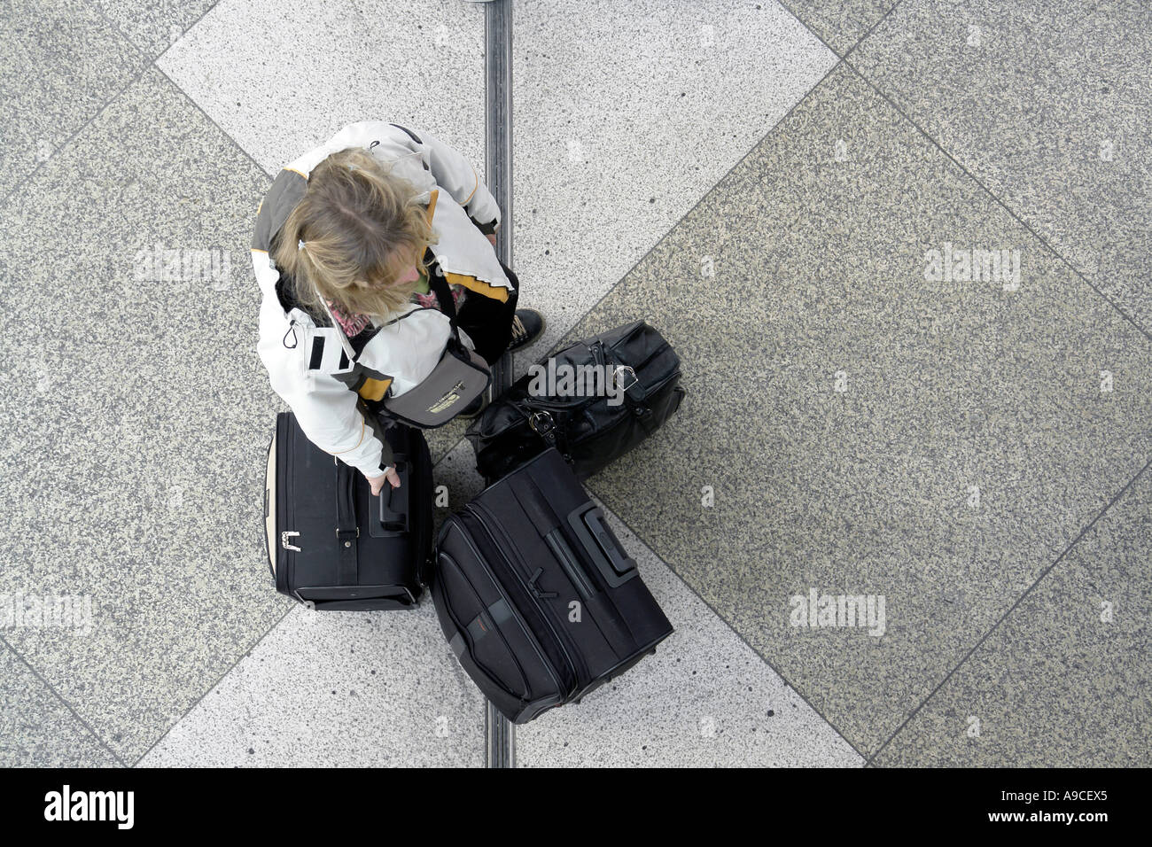 travellers at train station waiting check in Stock Photo - Alamy