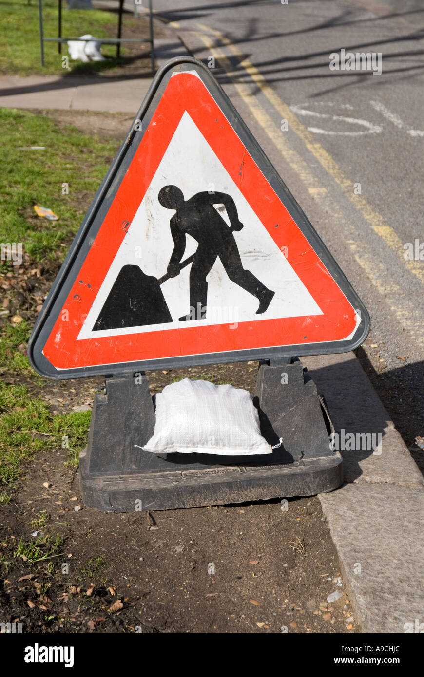 Sign indicating men at work up ahead Stock Photo - Alamy