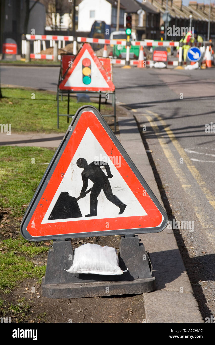 Sign indicating men at work and temporary traffic lights up ahead Stock ...