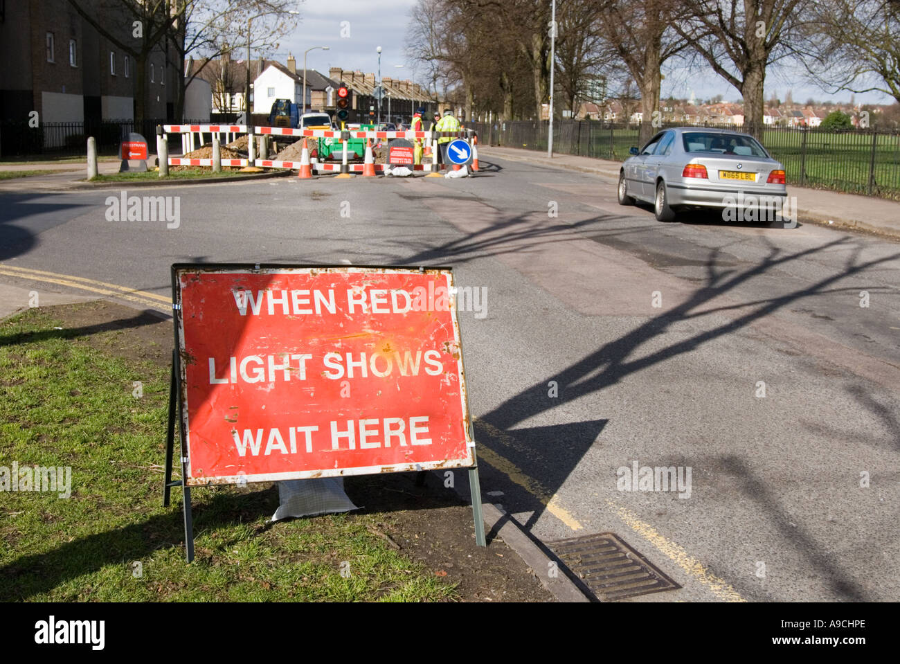 When red light shows wait here road sign Stock Photo - Alamy